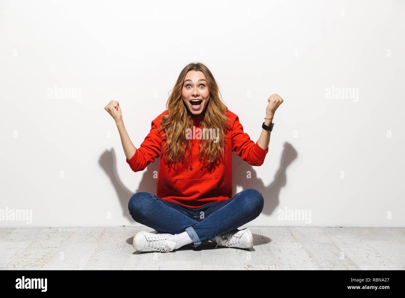 Full length photo of pleased woman 20s wearing casual clothes smiling ...