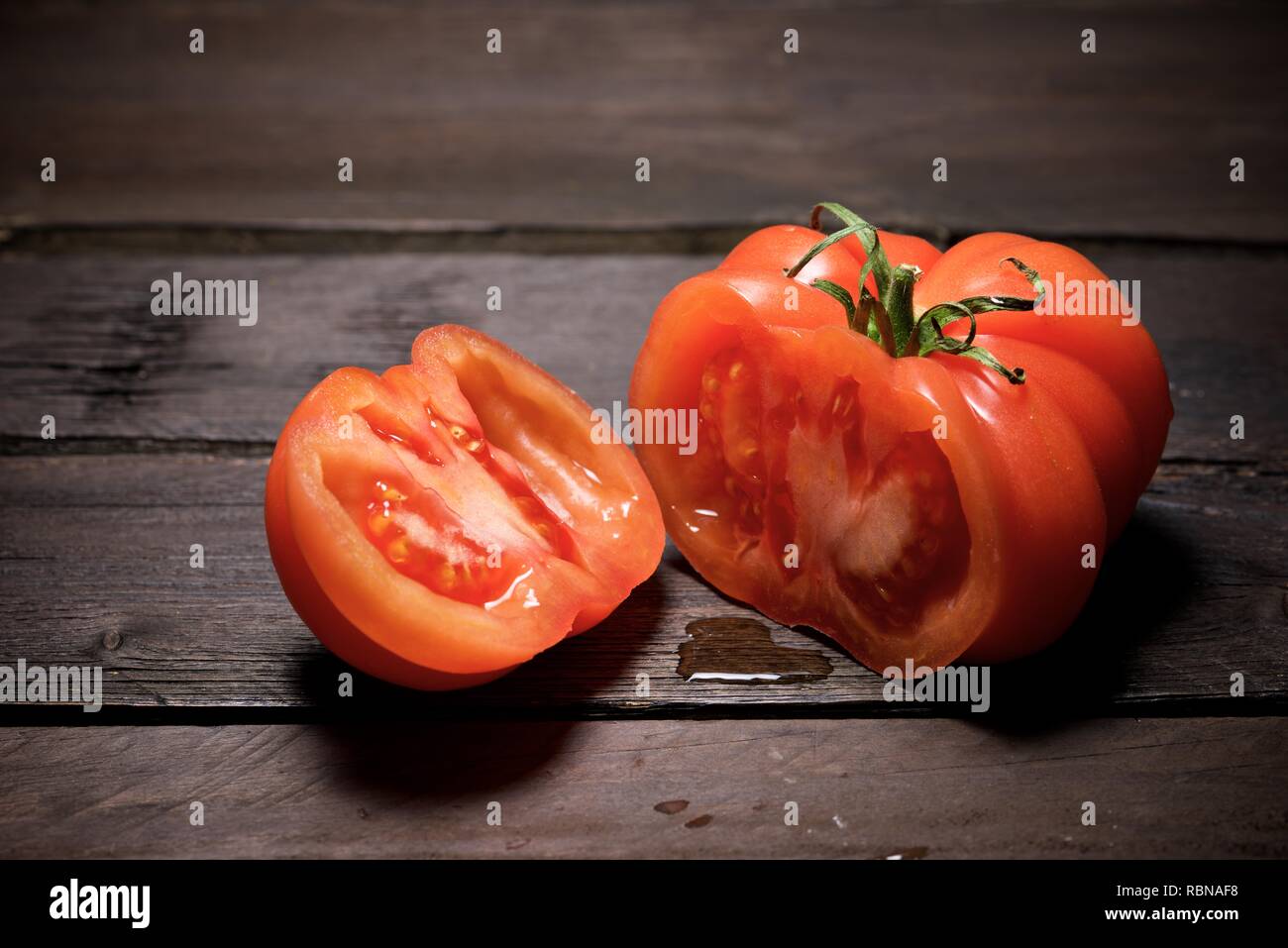 Tomato on a wood table Stock Photo - Alamy