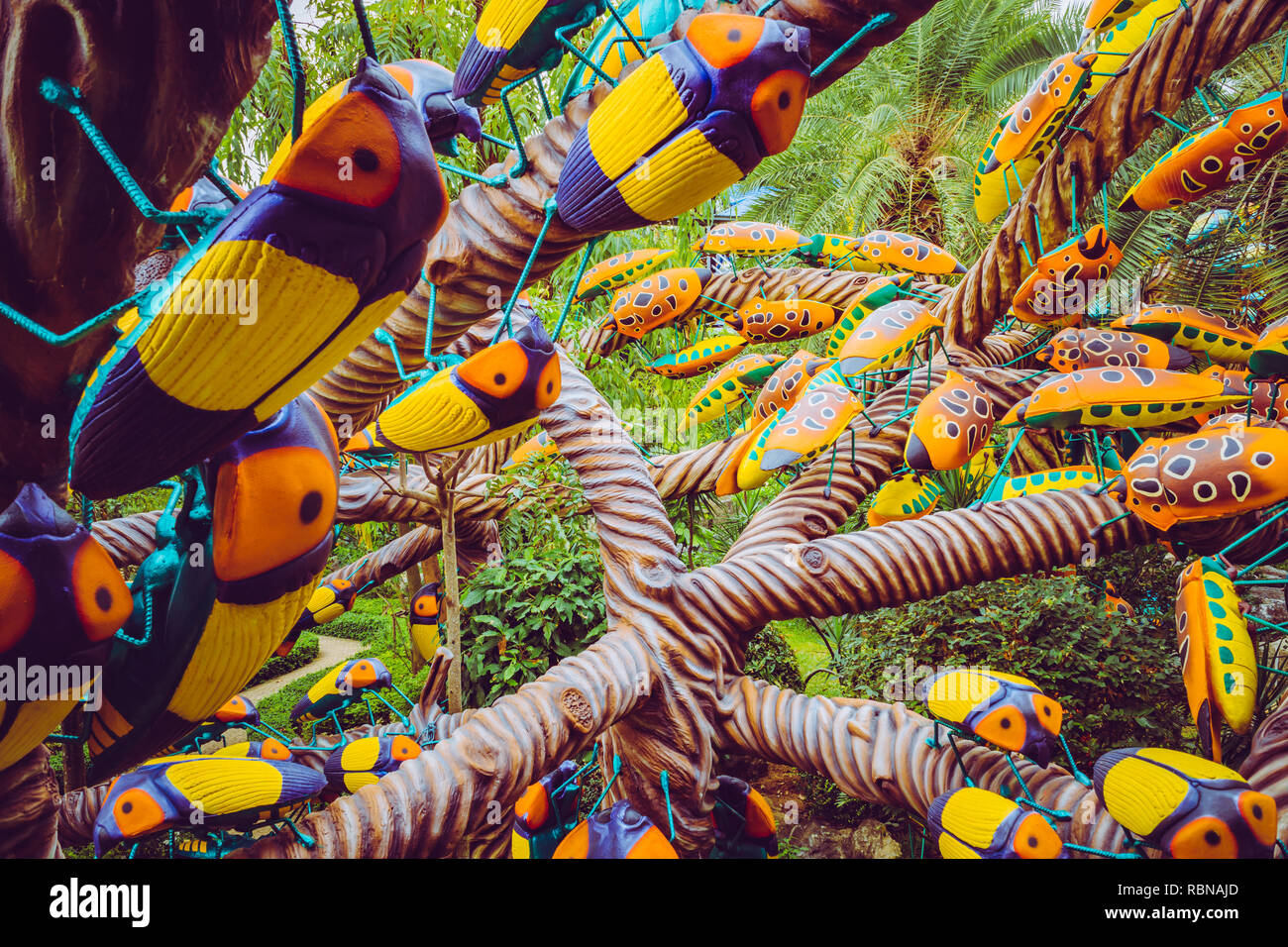 Playground with creative macro artworks of insects in a flower park in ...