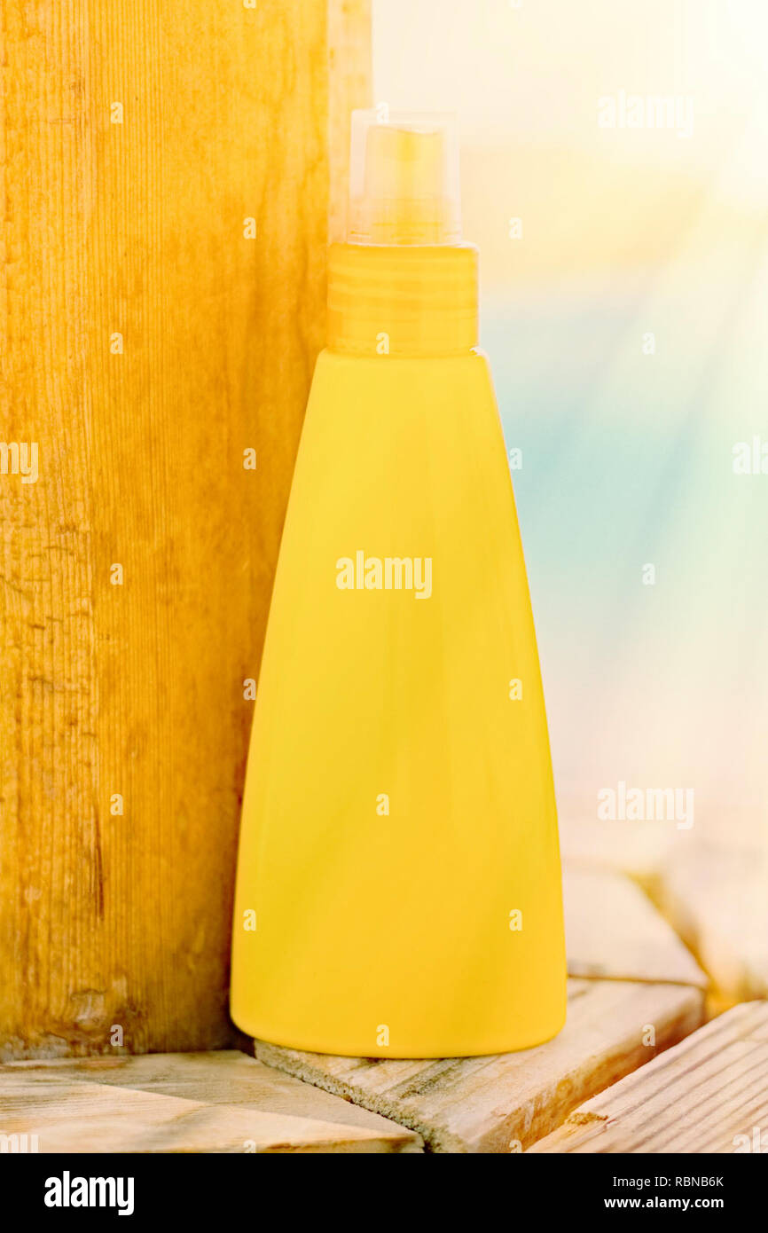 sun tan lotion on the beach - skincare cosmetics and holiday styled ...
