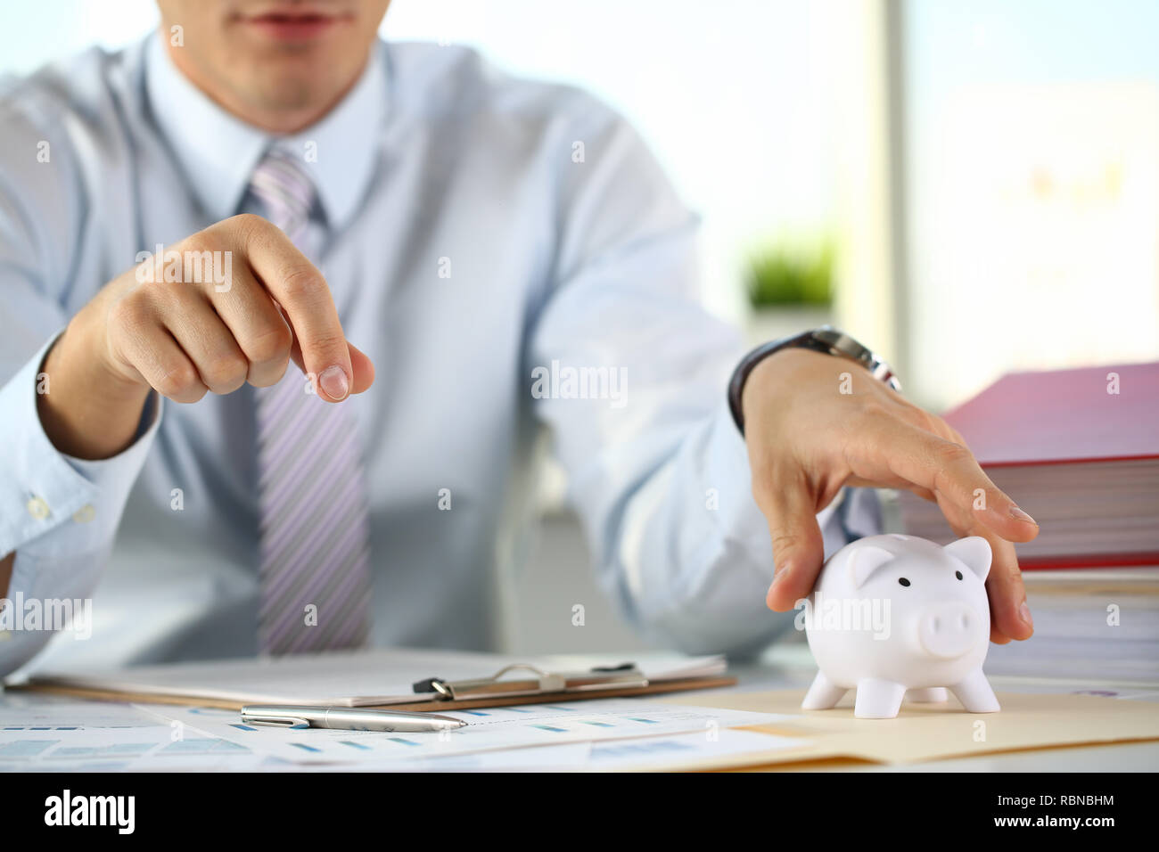 Hand businessman putting pin money Stock Photo - Alamy
