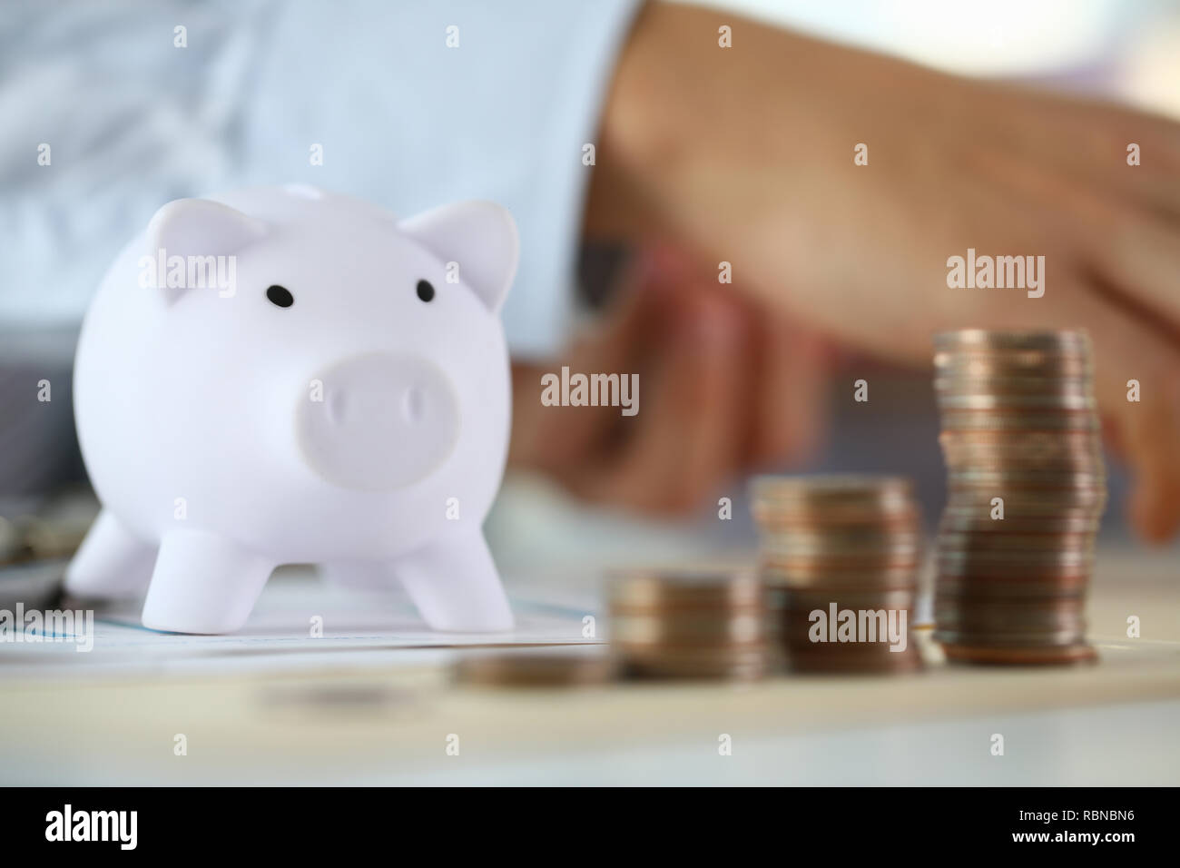 Hand businessman putting pin money Stock Photo - Alamy