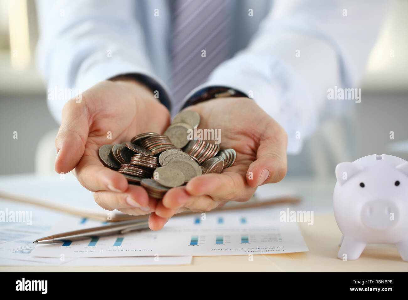 Hand businessman putting pin money Stock Photo - Alamy