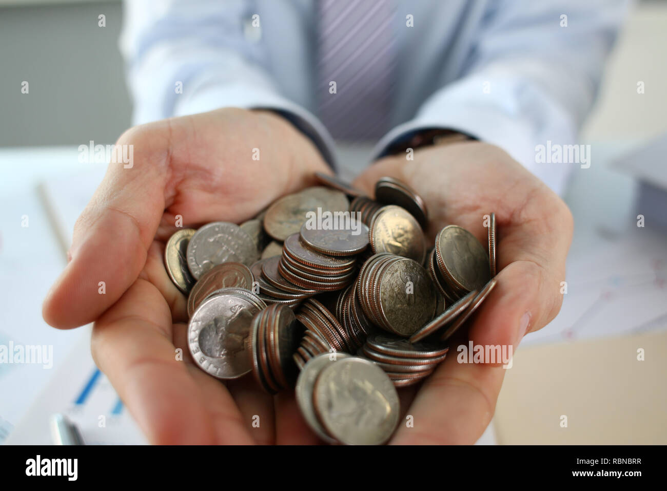 Hand businessman putting pin money Stock Photo - Alamy