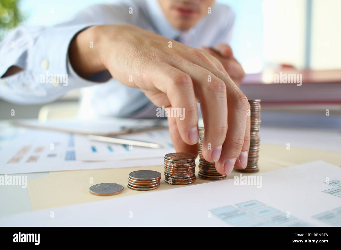 Hand businessman putting pin money Stock Photo - Alamy