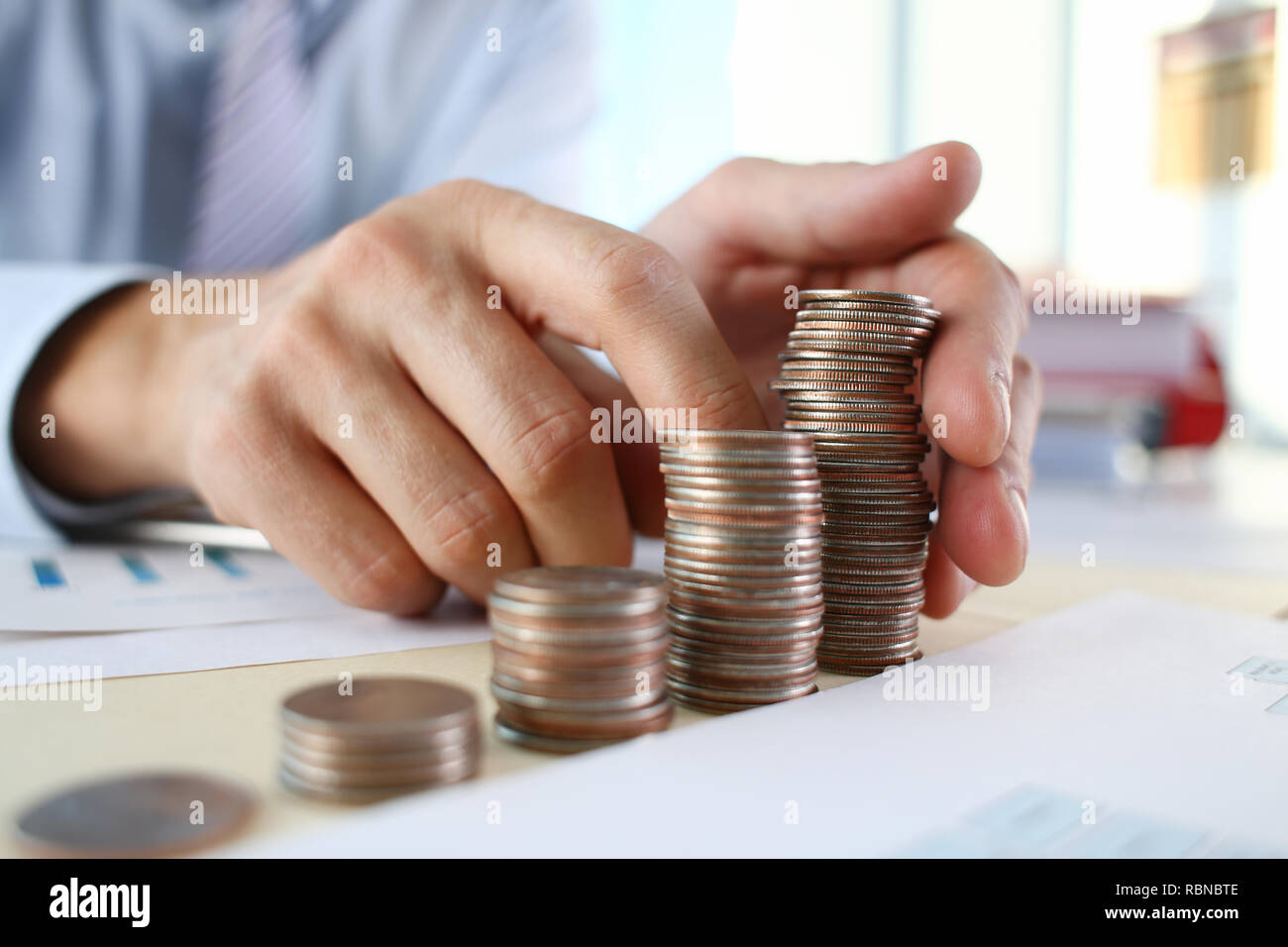 Hand businessman putting pin money Stock Photo - Alamy