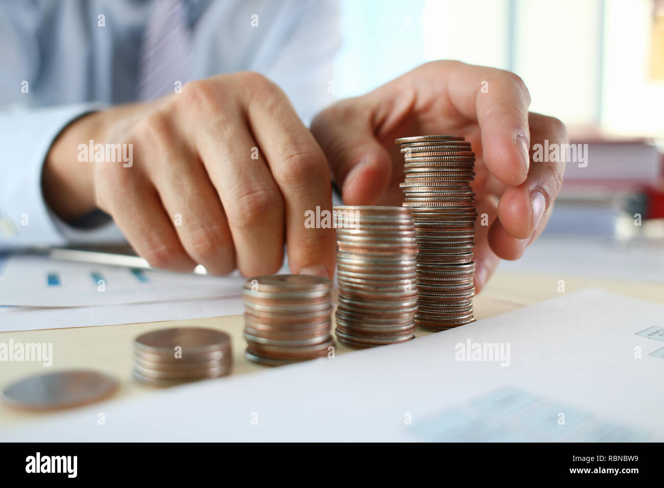 Hand businessman putting pin money Stock Photo - Alamy