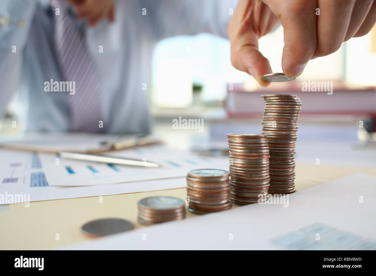 Hand businessman putting pin money Stock Photo - Alamy