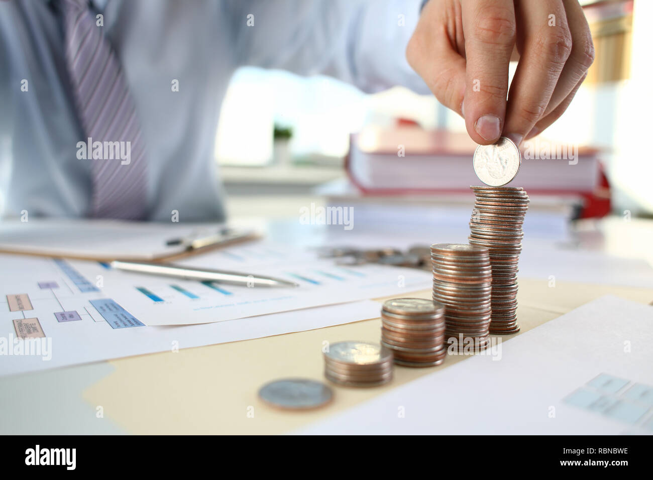 Hand businessman putting pin money Stock Photo - Alamy