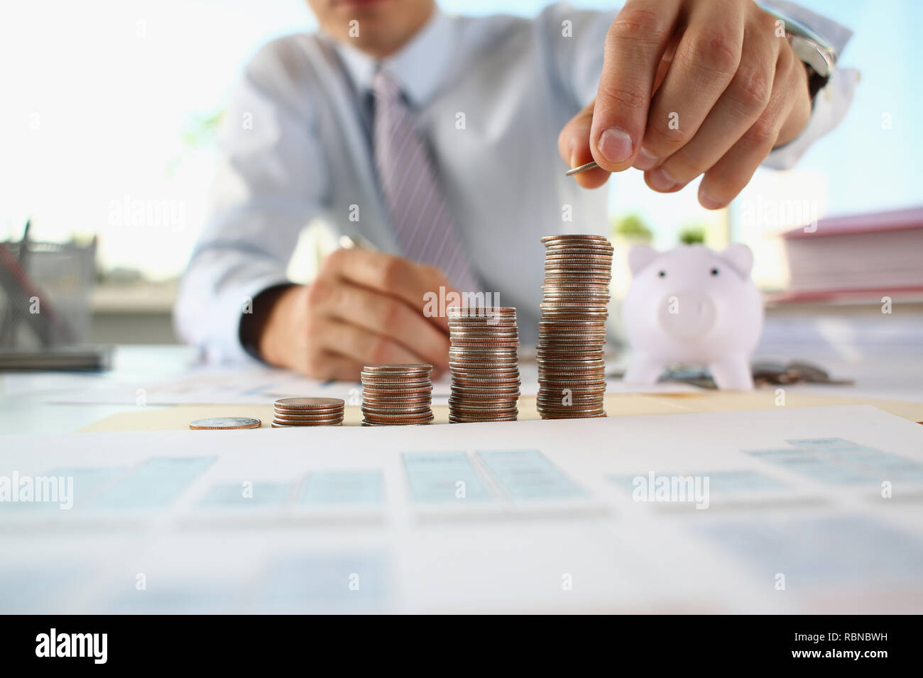 Hand businessman putting pin money Stock Photo - Alamy