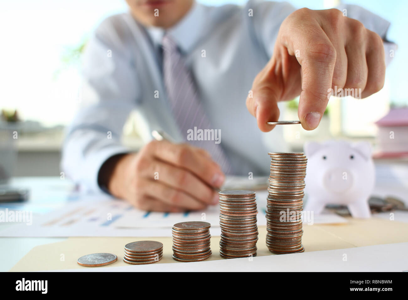 Hand businessman putting pin money Stock Photo - Alamy