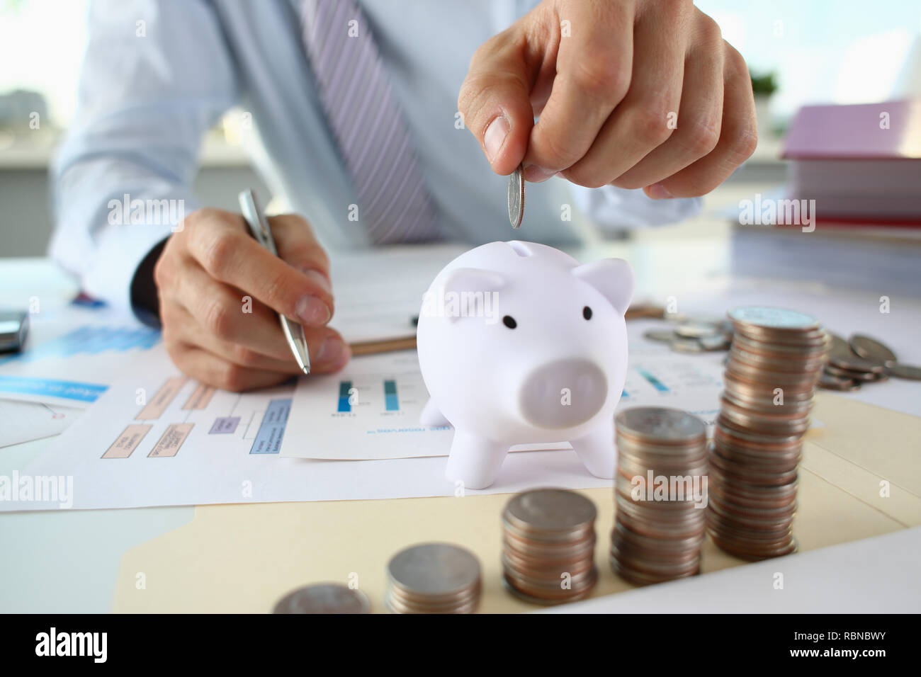 Hand businessman putting pin money Stock Photo - Alamy