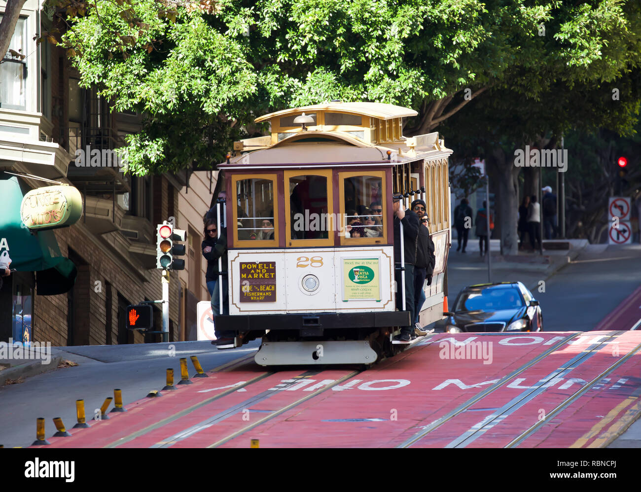 People ride the world famous cable car in San Francisco, USA Stock ...