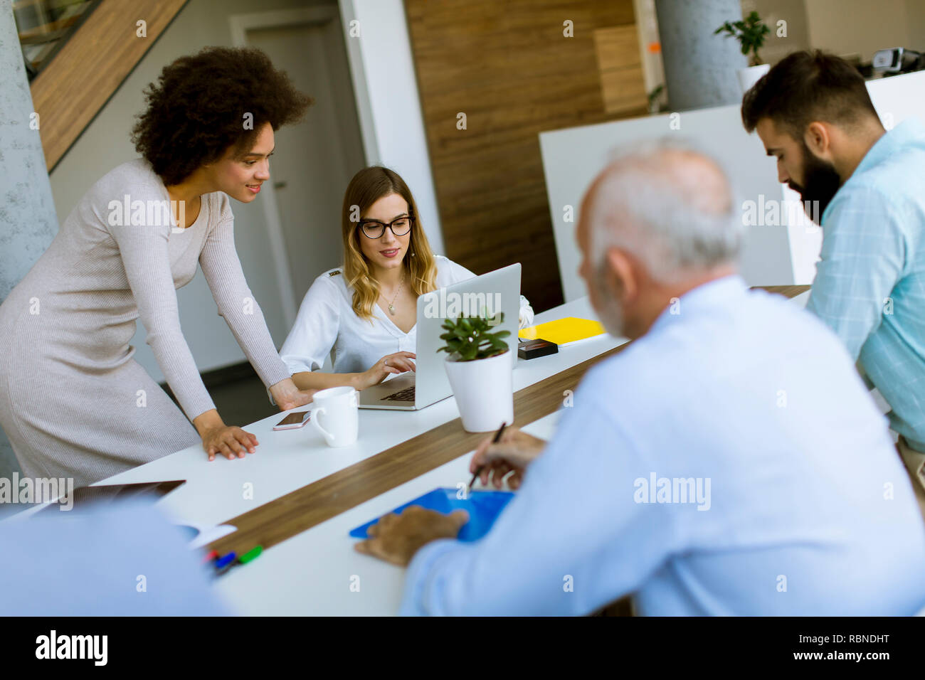 Successful business people discussing documents and working in modern ...