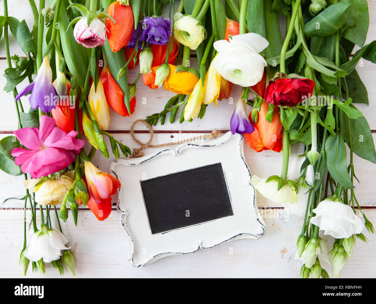 Colorful spring flowers on a rustic wooden background Stock Photo - Alamy