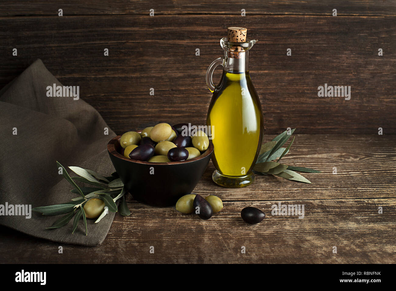 Bottle of Extra virgin healthy Olive oil with fresh olives close up ...