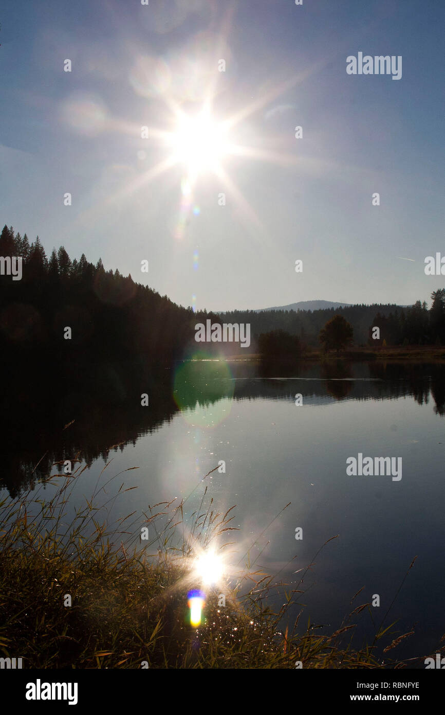 The sun shining in the water creating a double star reflection Stock ...