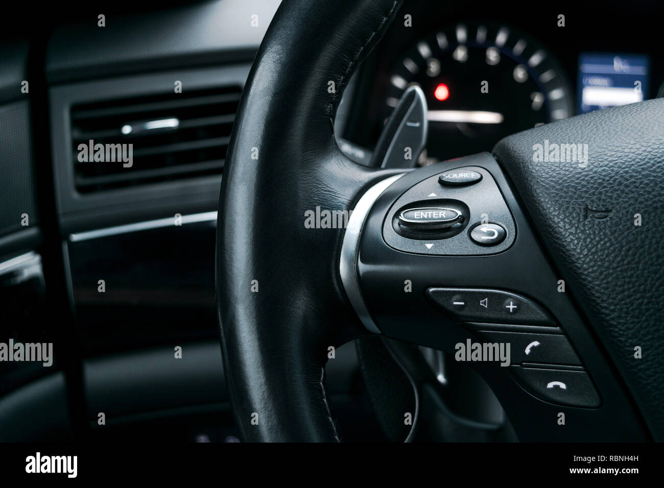 Media control buttons on the steering wheel in black perforated leather ...