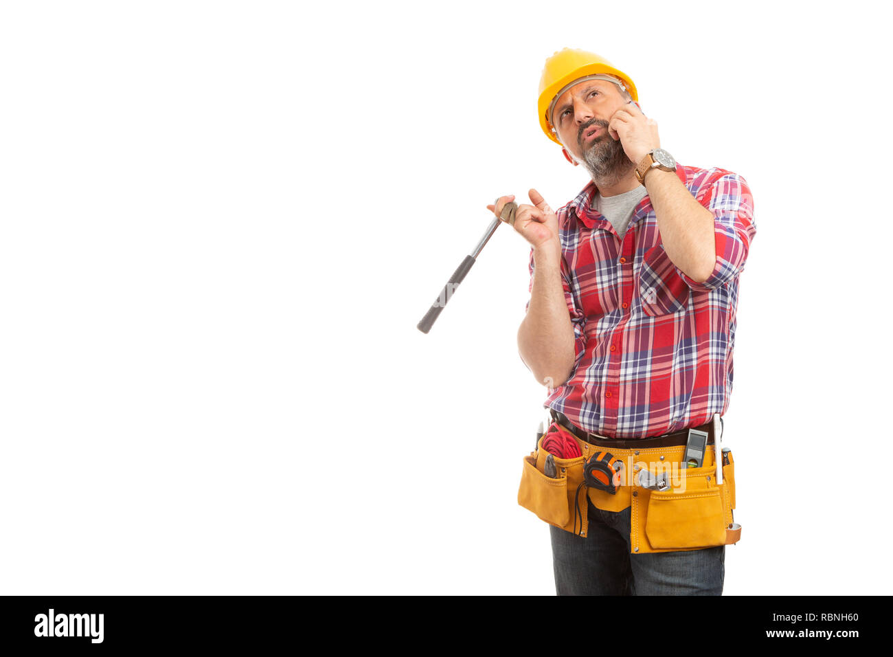 Construction foreman talking on the phone while holding hammer and ...