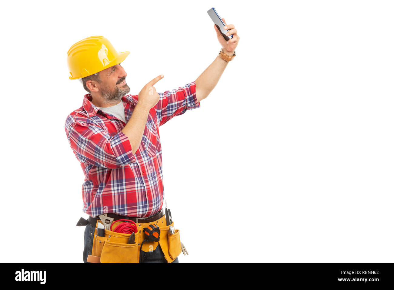Construction worker smiling as taking selfie with frontal camera as ...