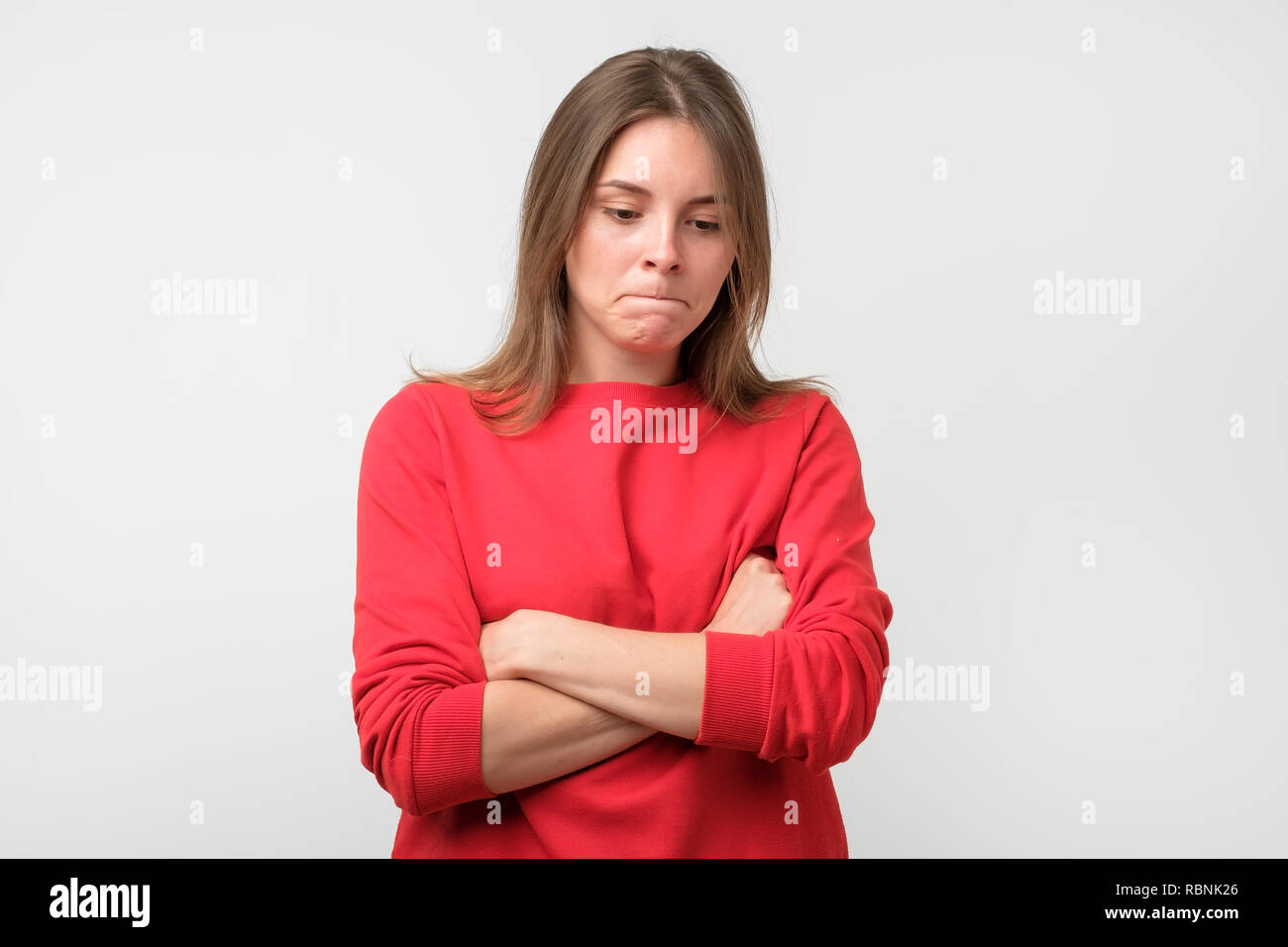young sad woman looking worried and thoughtful down. Expression feeling ...