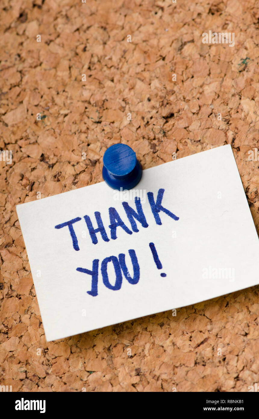 Thank you message on sticker note pin on cork office board. Business ...