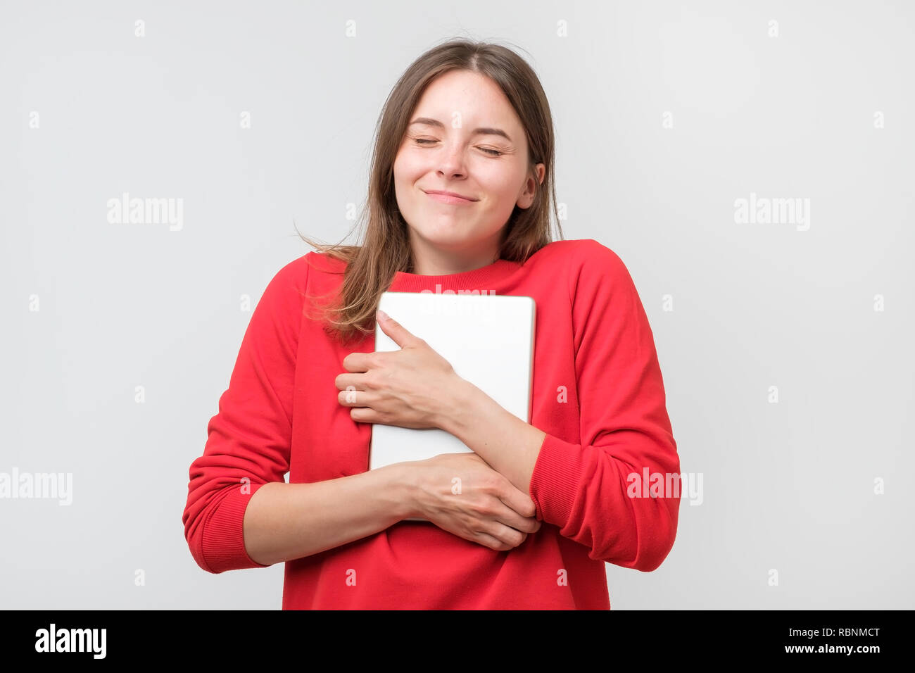 Student hugging laptop. Love to computer concept. Young emotional ...
