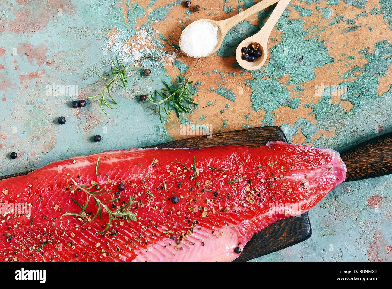 Gravlax, scandinavian beet cured spiced salmon on the board, top view ...