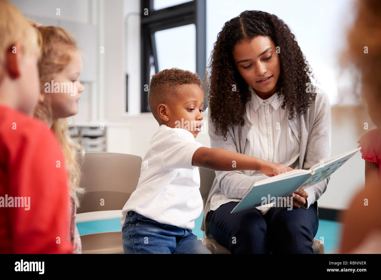 Three quarter length pointing holding hi-res stock photography and ...