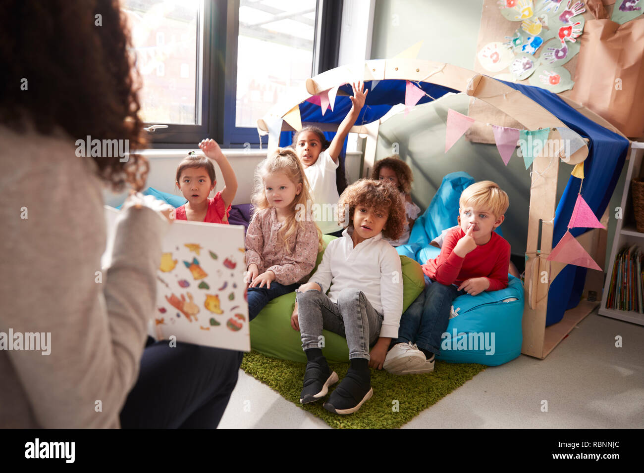 Children listening to adult in group hi-res stock photography and ...