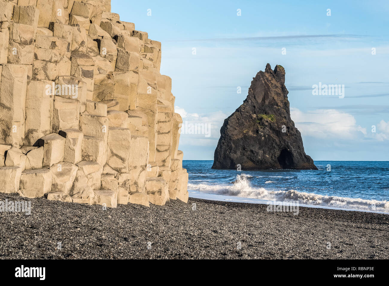 basalt formation on beach with big rock in the ocean on Icelabd Stock ...