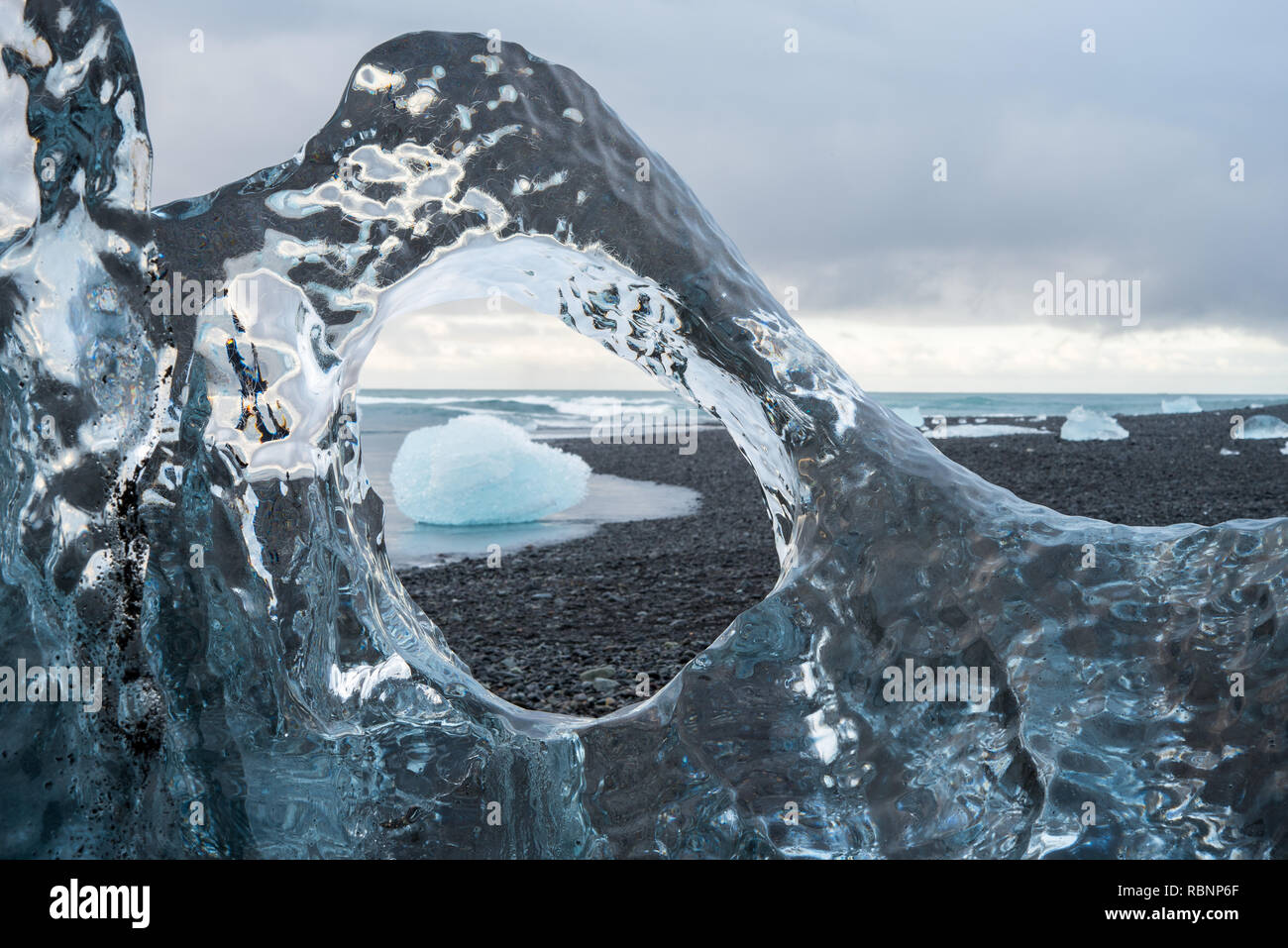 view through a window of a transparent iceberg at the ocean Stock Photo ...