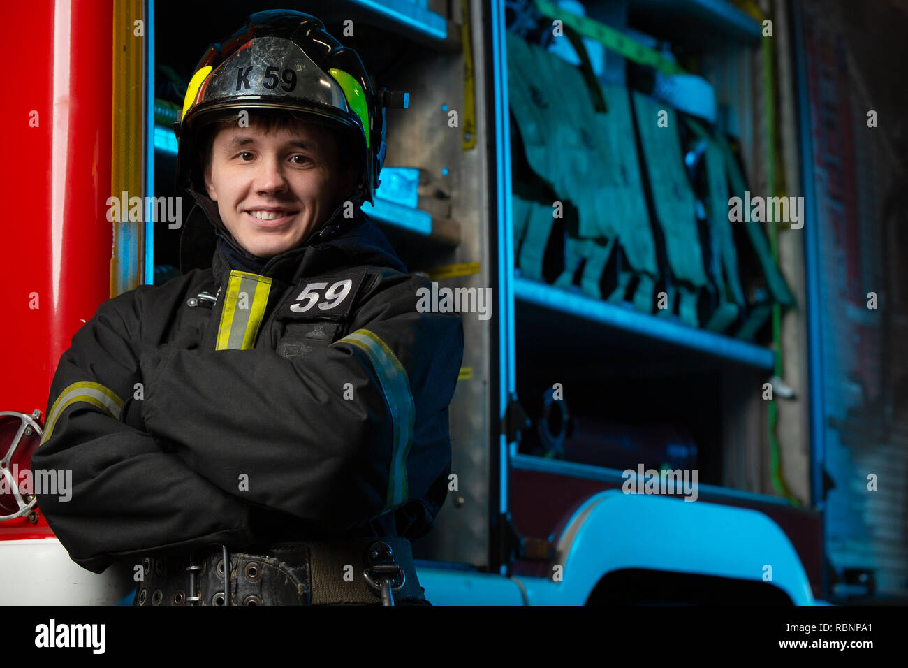 Photo of smiling man firefighter with arms crossed Stock Photo - Alamy