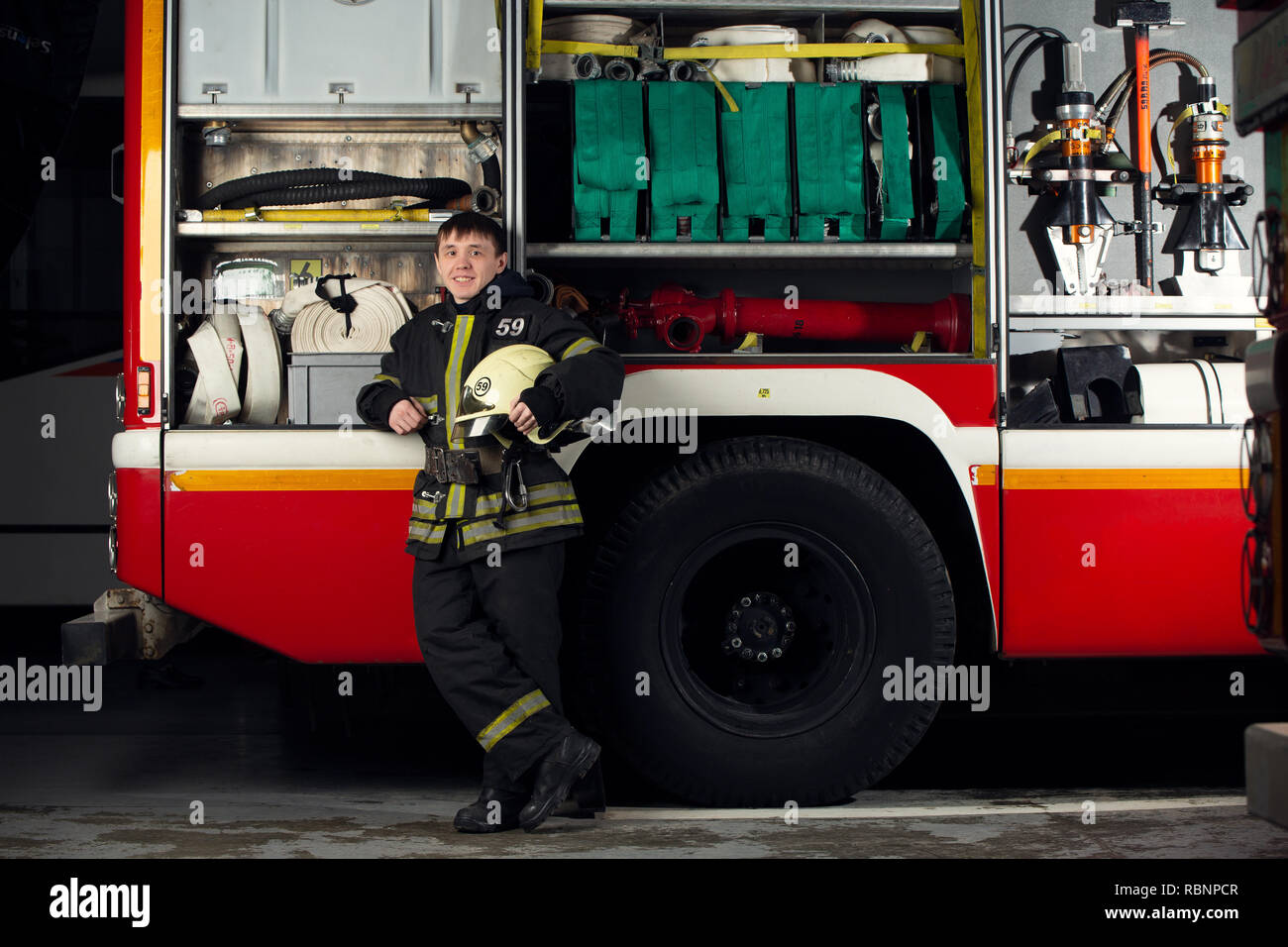 Image of fireman man near fire truck at station Stock Photo - Alamy