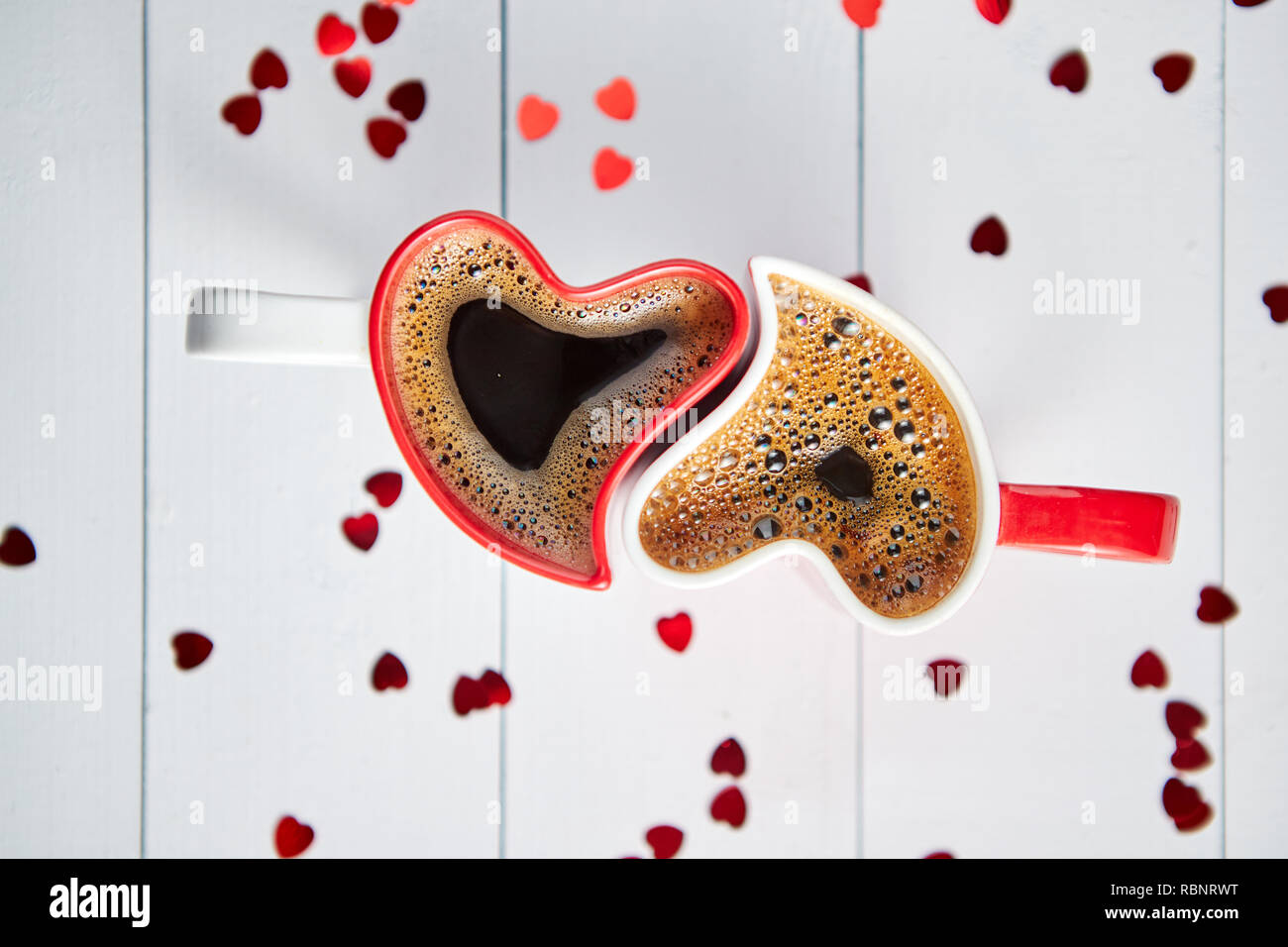 Two heart shaped coffee cups conected with each other Stock Photo - Alamy