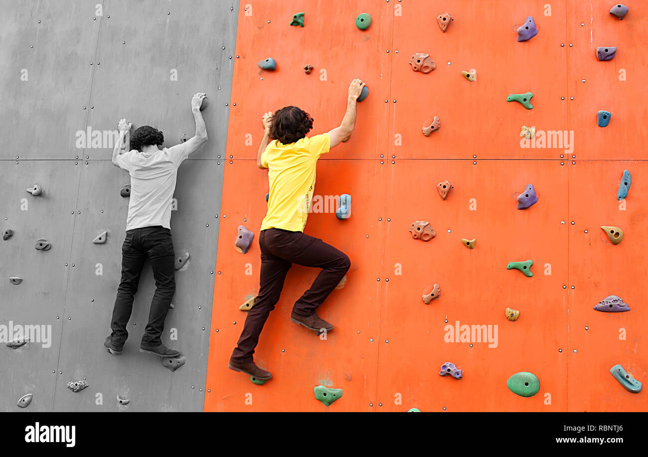 Man climbing over wall hi-res stock photography and images - Alamy