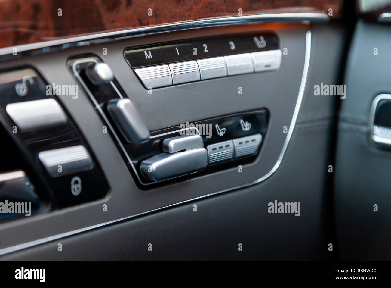 Automatic seat memory buttons with white signs and symbols located ...