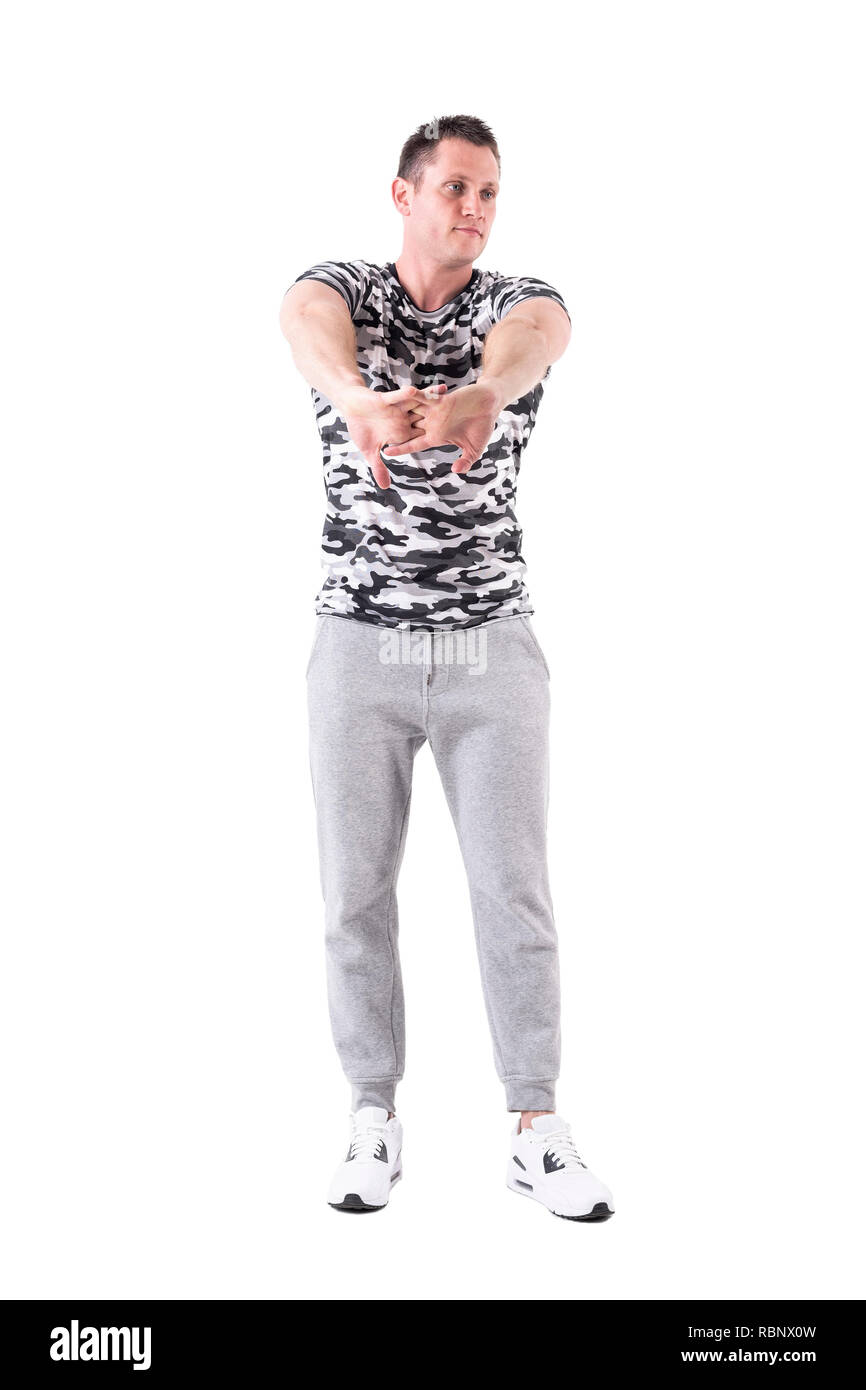 Athletic fit sport man stretching arms warming up and preparing for ...