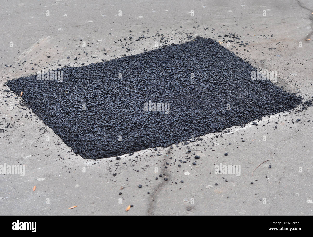 Close up on asphalt road repair. Repair pavement and laying new asphalt ...