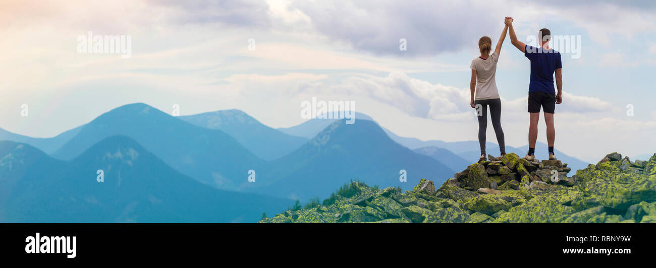 Back view of young tourist couple, athletic man and slim girl standing ...