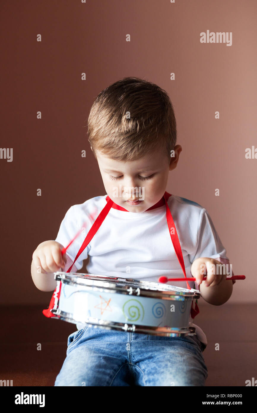 Little boy playing the drum. Lovely baby boy. Child development concept ...