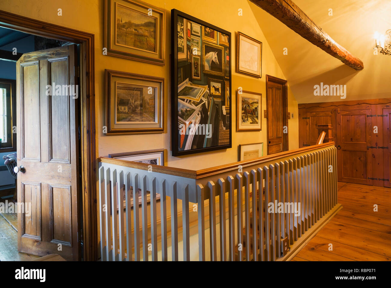 Opened guest bedroom pinewood door and railings surrounding staircase ...