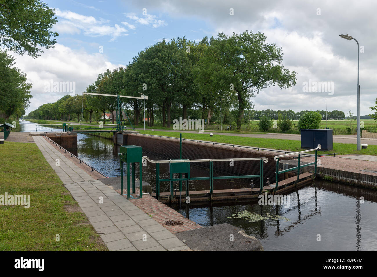 Dutch rural landscape with canal and old sluice Stock Photo - Alamy