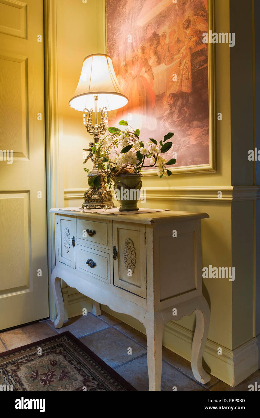 Antique wooden console with lamp and flower vase in the kitchen ...