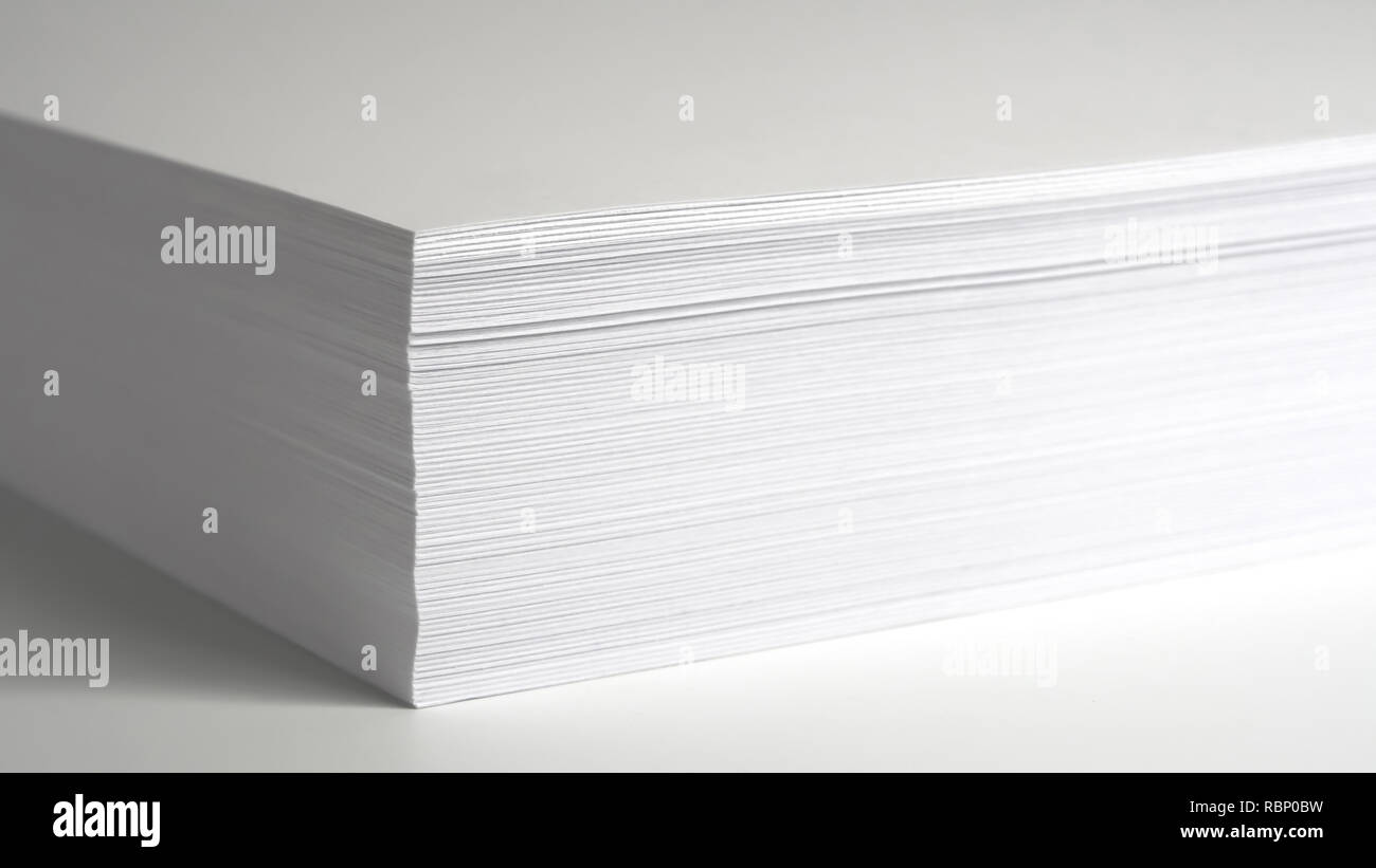 stack of white printer paper on a white background Stock Photo - Alamy