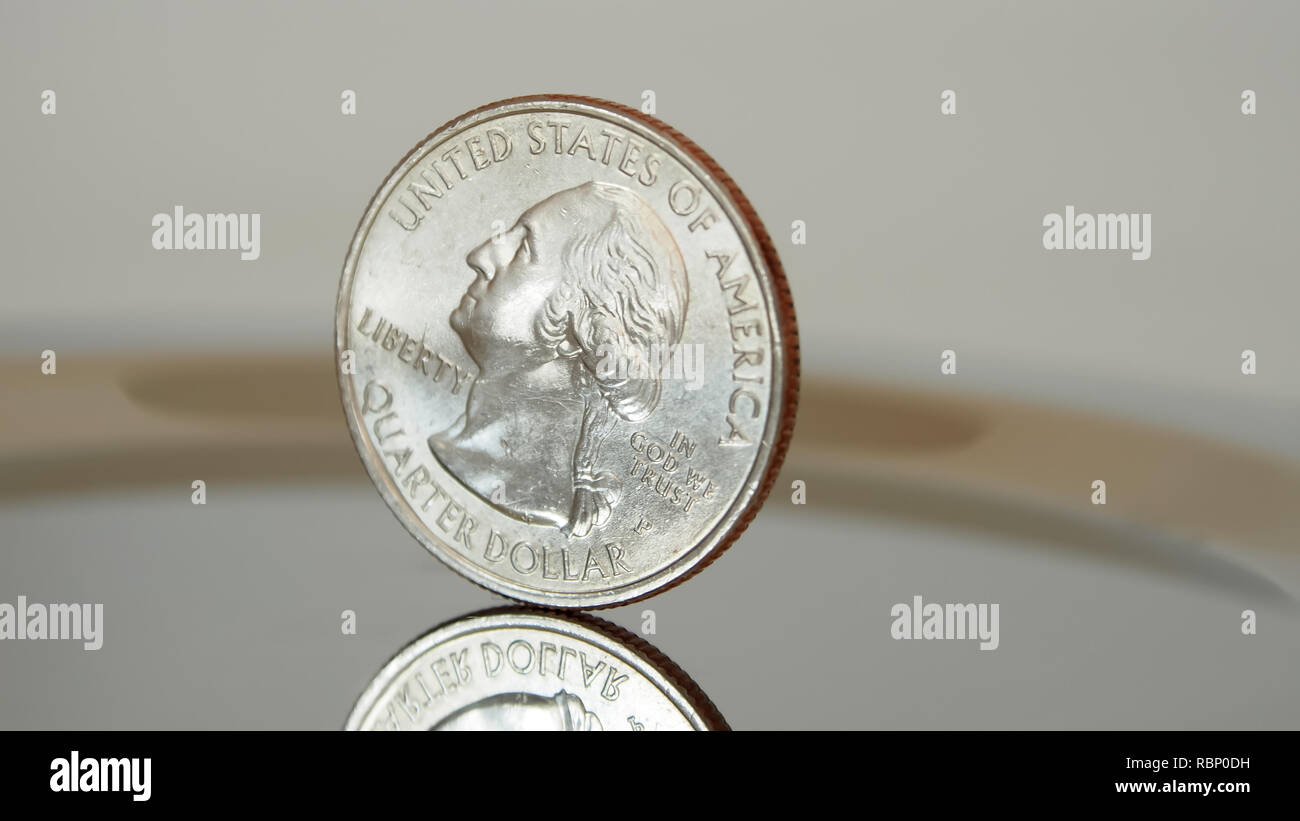 quarter dollar coin on a reflecting metal tray Stock Photo - Alamy