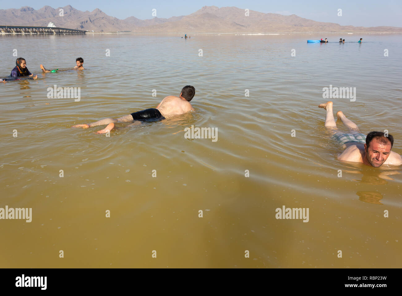 People are swimming in the salt Urmia Lake, West Azerbaijan province ...