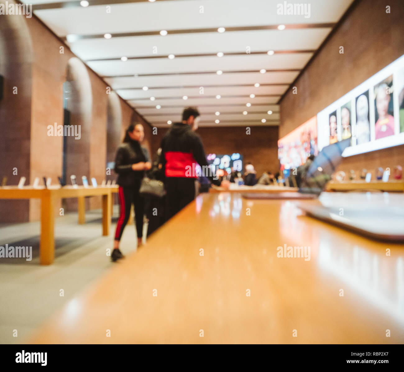 Defocused silhouettes of people inside computer store Stock Photo - Alamy
