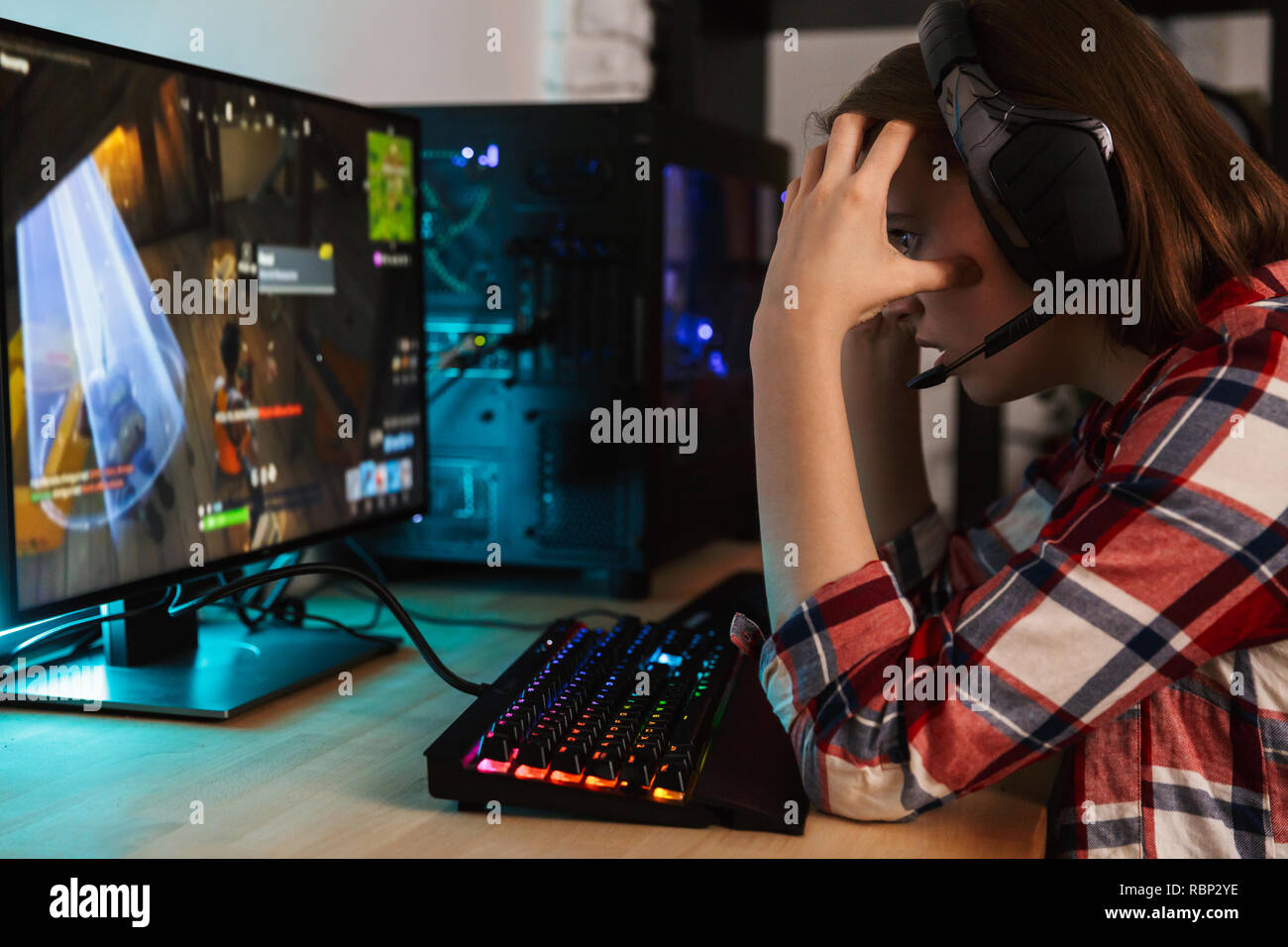 Nervous angry young woman gamer playing online computer games at the ...