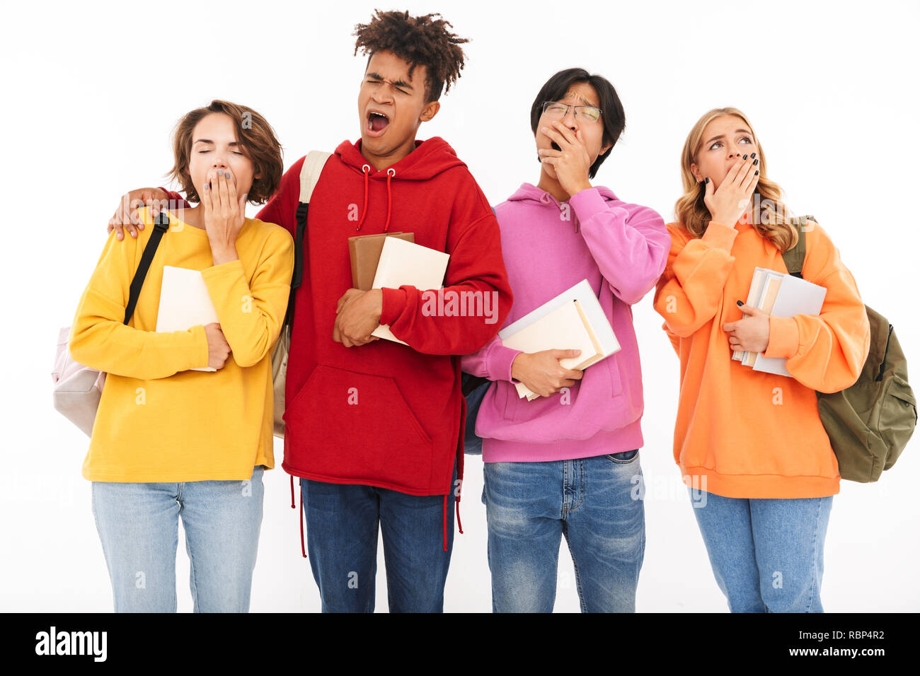 Photo of tired young group of friends students standing isolated over ...
